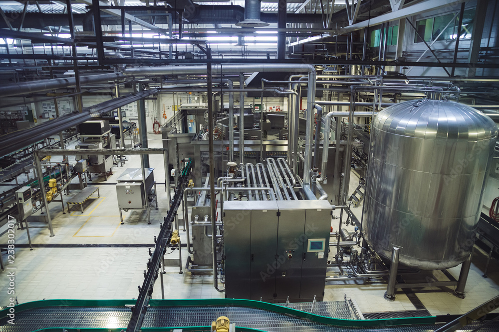 Modern brewery production line. Large vat for beer fermentation and ...