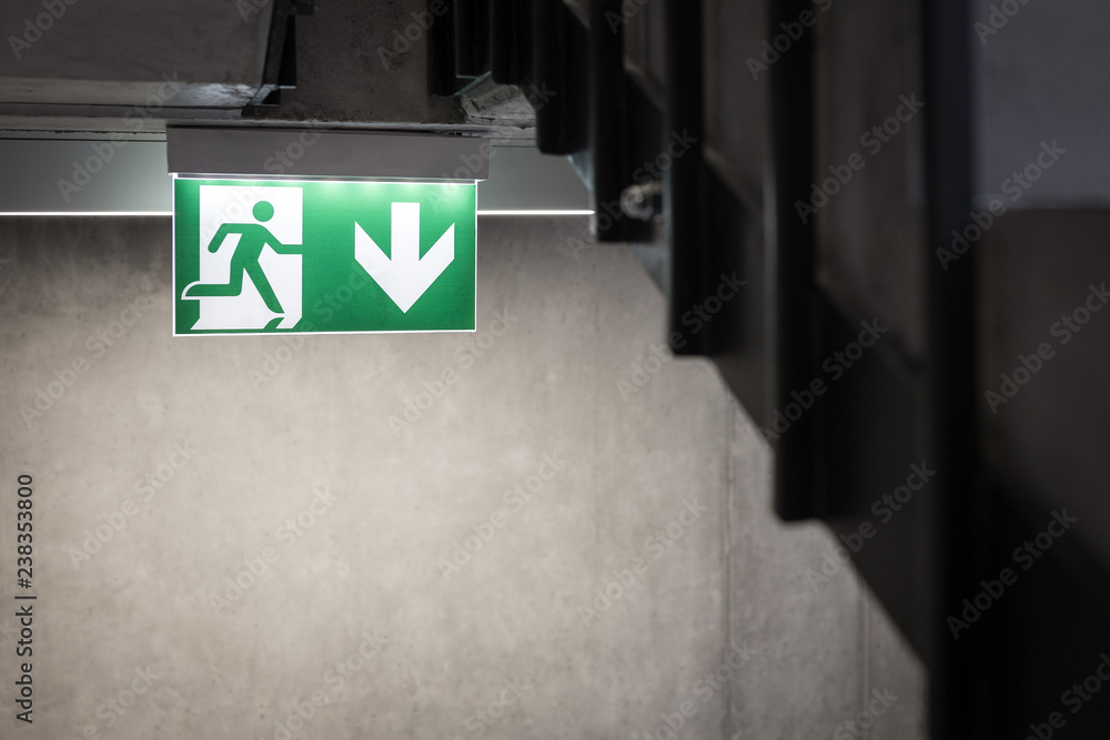 Symbol of escape route in case of danger, Modern concrete building with ...