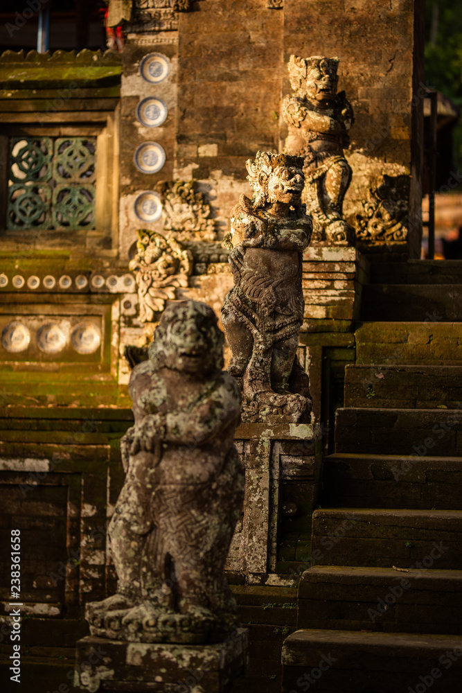Stone carved demons protecting the staircase entrance of Pura Kehen ...