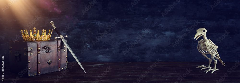 low key banner of beautiful queen/king crown, bird skeleton and sword ...