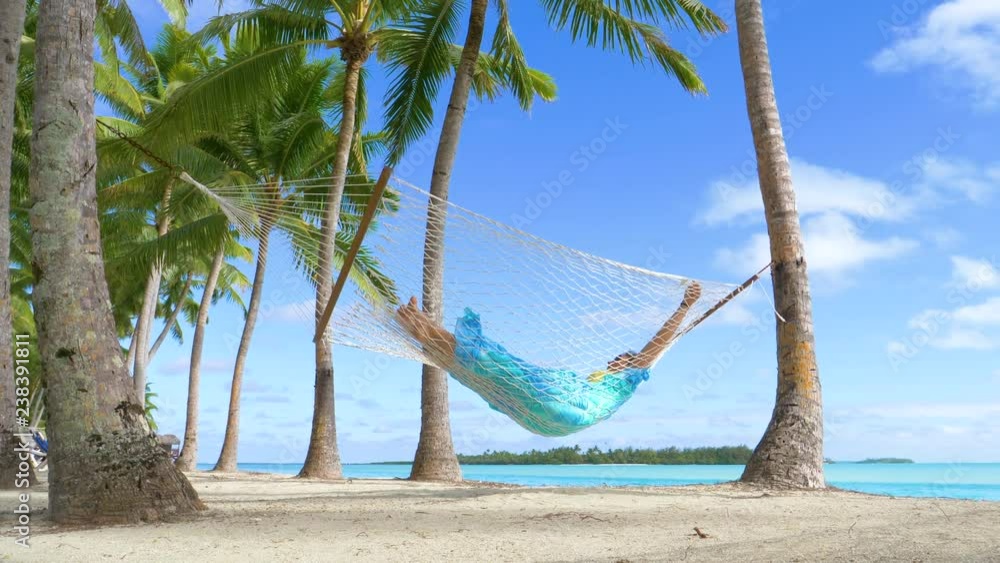 LOW ANGLE: Female traveler unwinds by the breathtaking ocean by taking ...