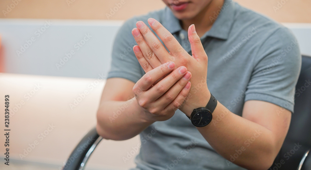 man massage on his hand and arm for relief pain from hard working ...