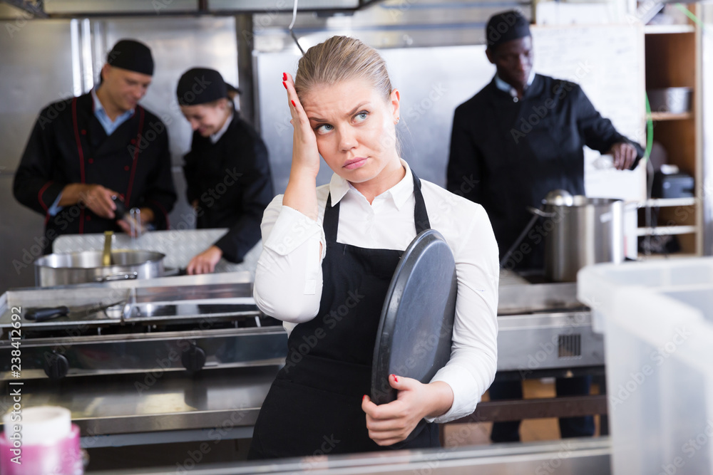 Disappointed waitress in restaurant kitchen Stock Photo | Adobe Stock