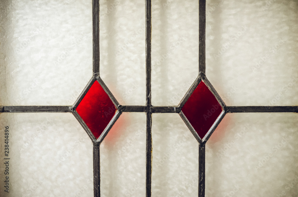 Close-up of leaded stained glass window with red diamond patterns Stock ...