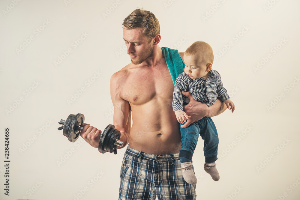Time to sport. Father build biceps triceps with son. Healthy family ...