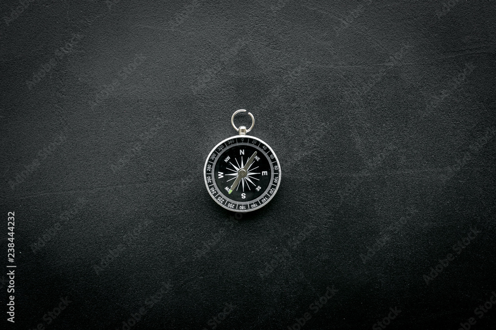 direction and movement concept with compass on black background top ...