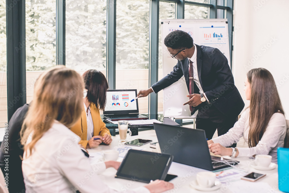 Discussing new business ideas. Cheerful young Afro American Man ...