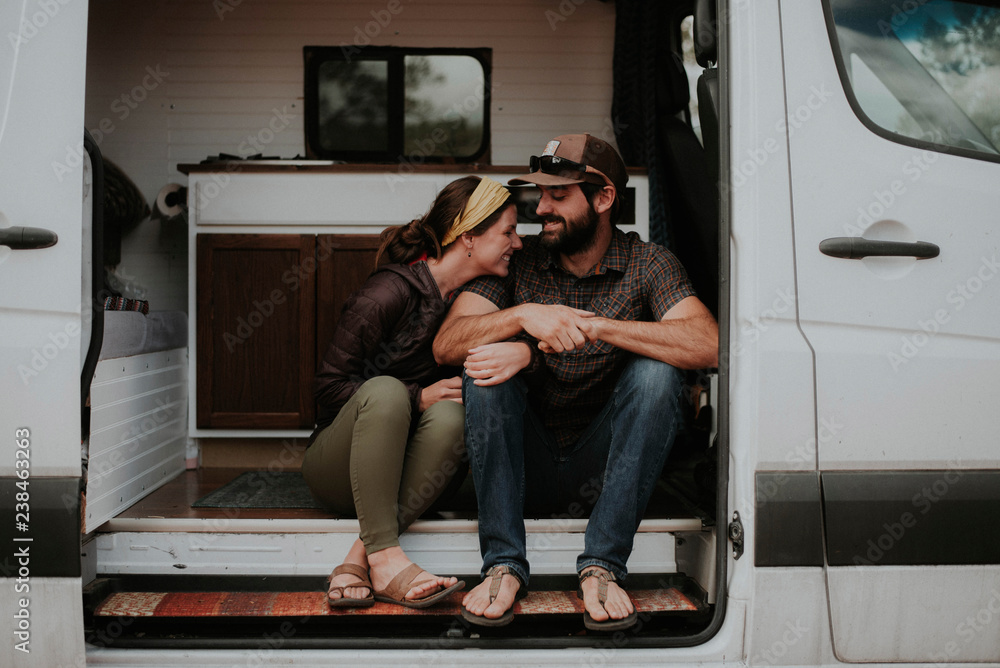 Smiling couple sitting in motorhome Stock Photo | Adobe Stock