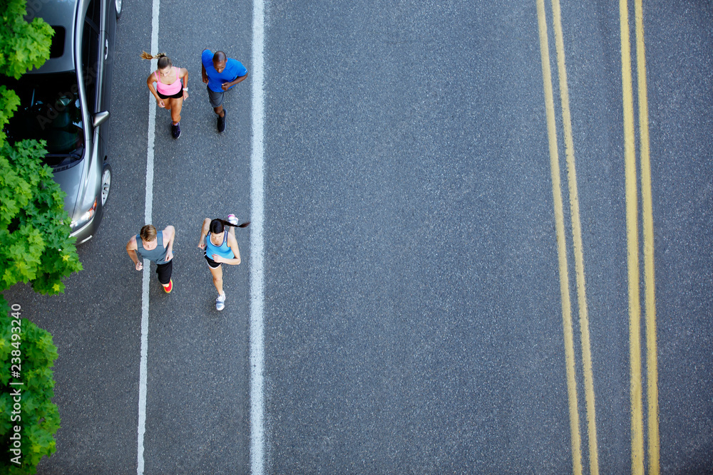 Overhead view of athlete friends running on road Stock Photo | Adobe Stock