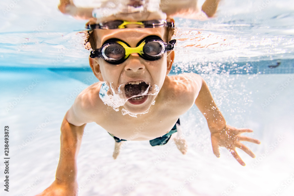 Portrait of shirtless boy with mouth open swimming in pool Stock Photo ...