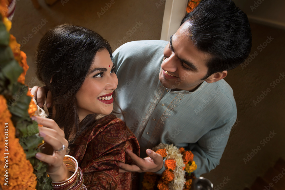 The newlywed couple in traditional dress performing rituals Stock Photo ...