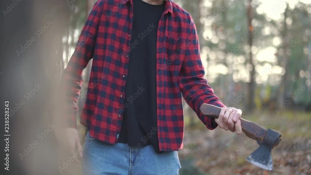Man in the forest juggling with axe. Guy with an axe outdoors. Stock ...