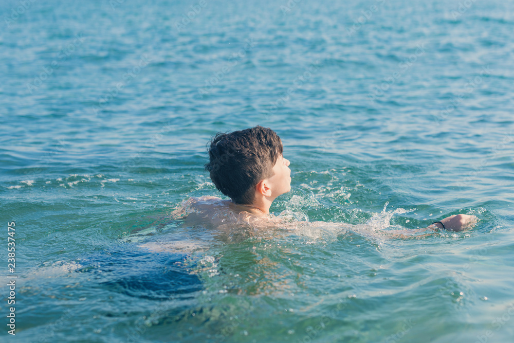 Boy Swimming In Ocean