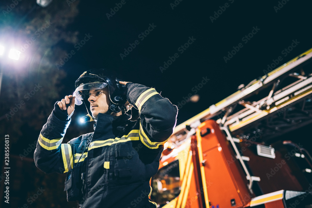 Fireman man posing to camera. Stock-Foto | Adobe Stock