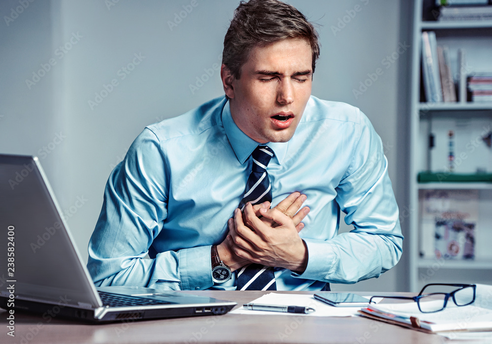 Office manager having heart attack. Photo of young man holding hand on ...