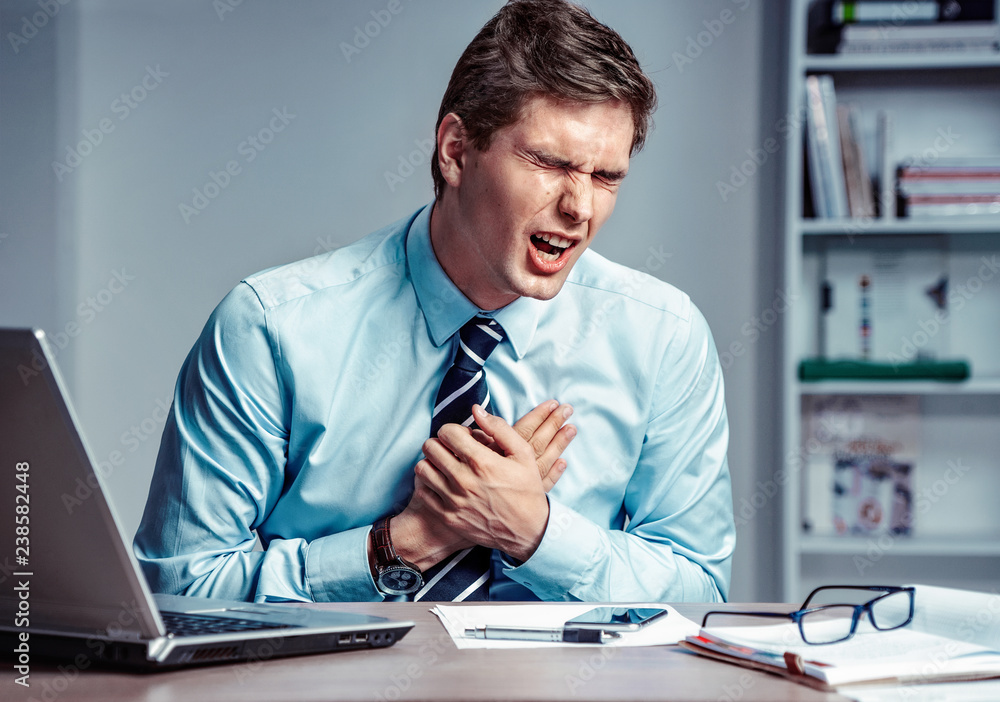 Office manager having heart attack. Photo of young man holding hand on ...