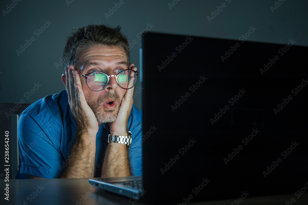 weird shocked and surprised geek man in nerd glasses working on laptop ...