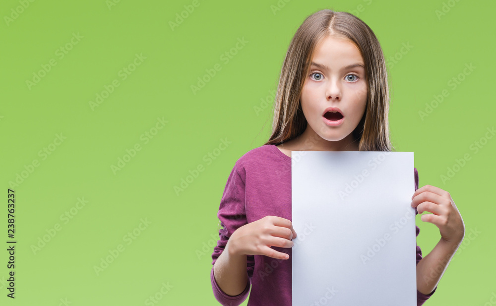 Young beautiful girl holding blank sheet paper over isolated background ...