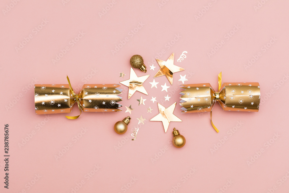 Christmas crackers. luxury gold festive cracker on a pastel pink ...