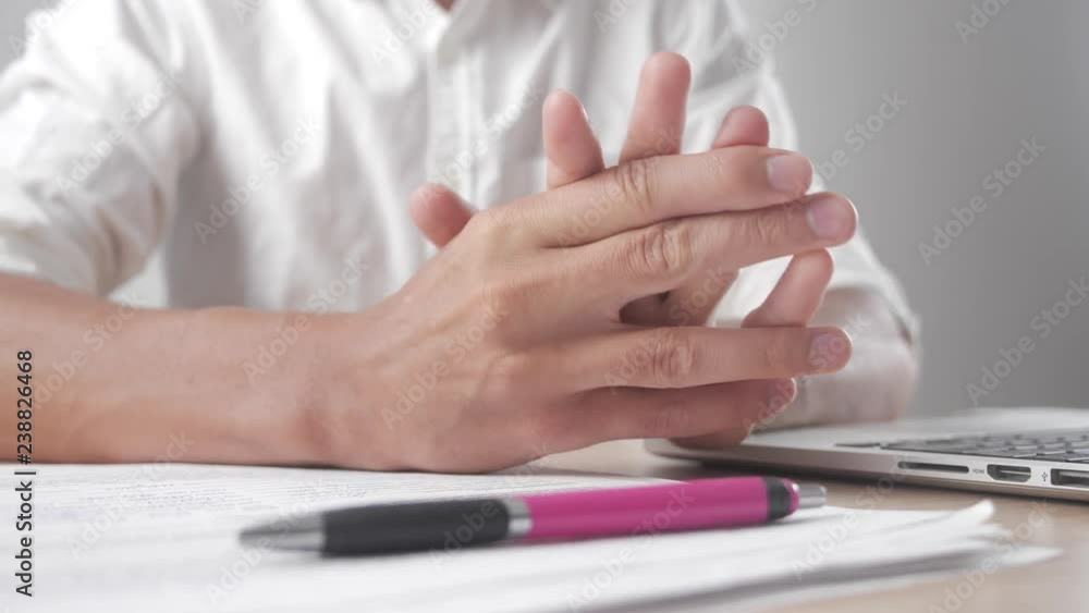 Hands of man being anxious, nervous and uncomfortable at workplace ...