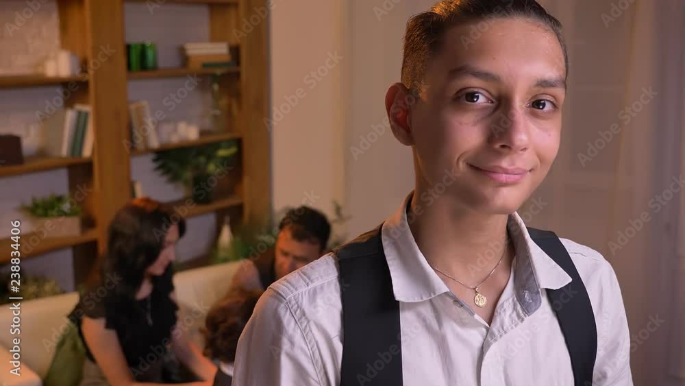 Portrait of teenage arabic boy watching directly into camera with ...