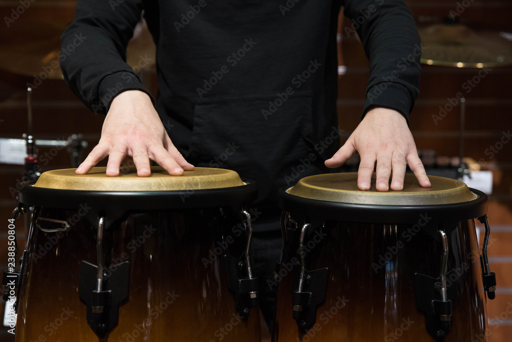 Professional percussion drum set closeup. Man drummer playing kongo ...