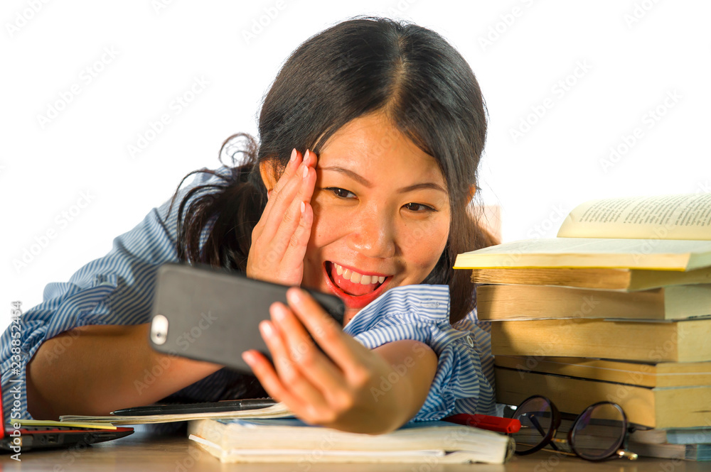 young happy and successful Asian Chinese student girl taking selfie ...
