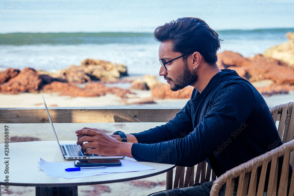 freelancing and remote work.handsome male student working laptop ...