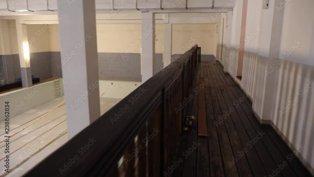 Empty indoor swimming pool drained with no water in an old school or ...
