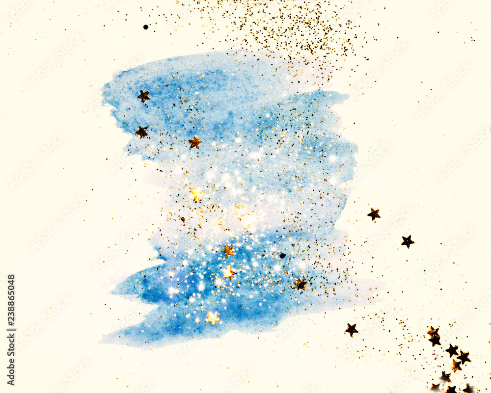 Golden glitter and glittering stars on abstract blue watercolor splash ...