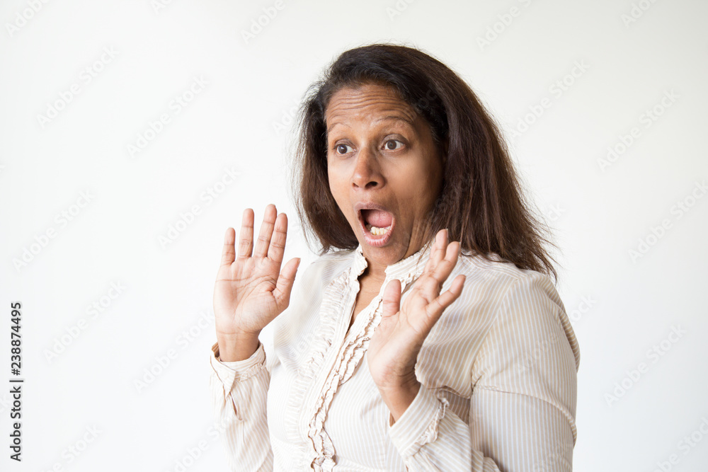 Scared Latin woman shocked with scene. Middle aged lady shouting and ...