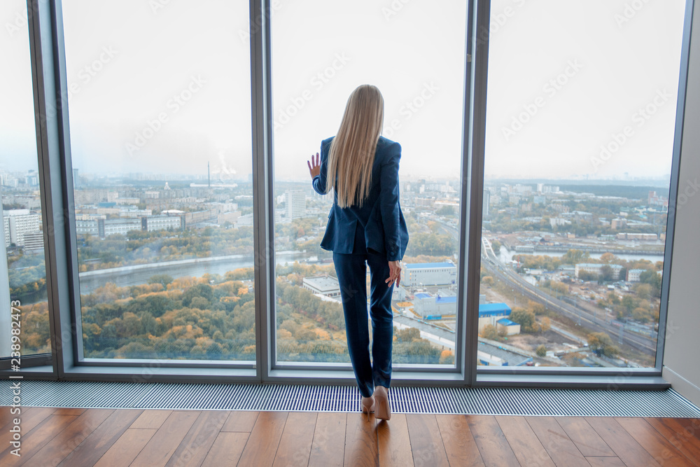 Young stylish beautiful blond business woman in a skyscraper in the ...