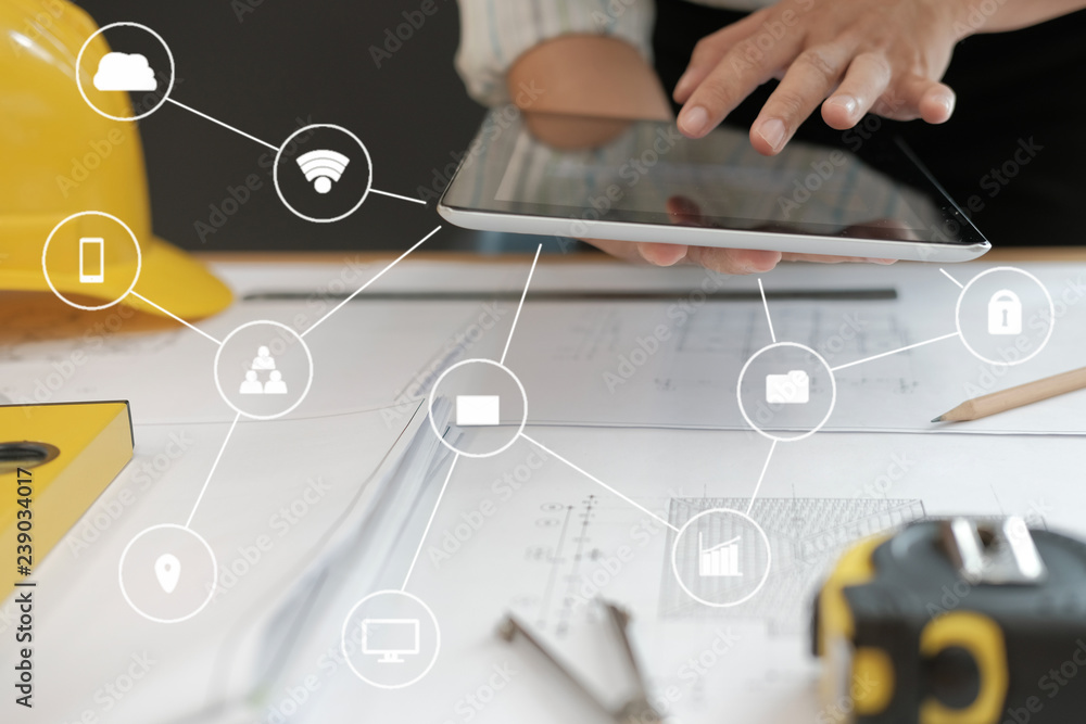 architect using tablet. engineer working on house blueprint of real ...