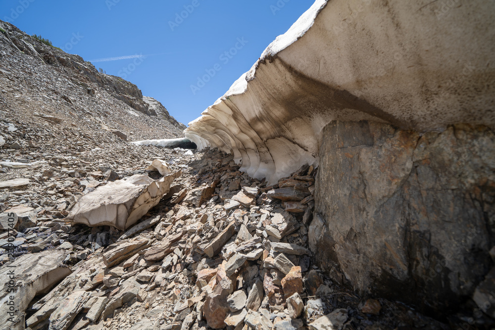 Remaining snow cave along the trail of the 20 Lakes Basin hike in ...