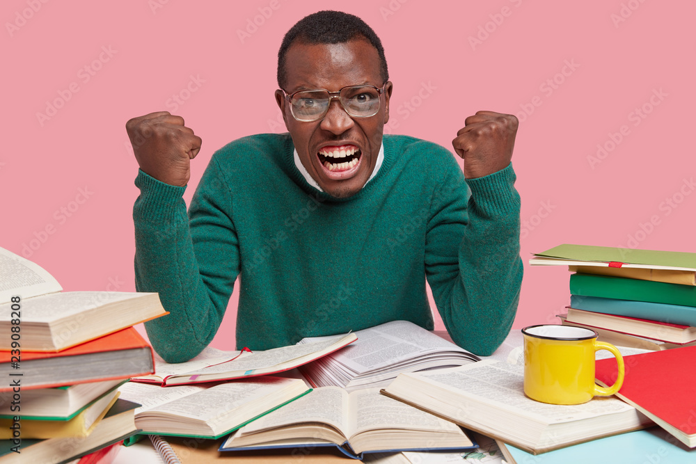 Horizontal shot of angry annoyed furious black scientific worker ...