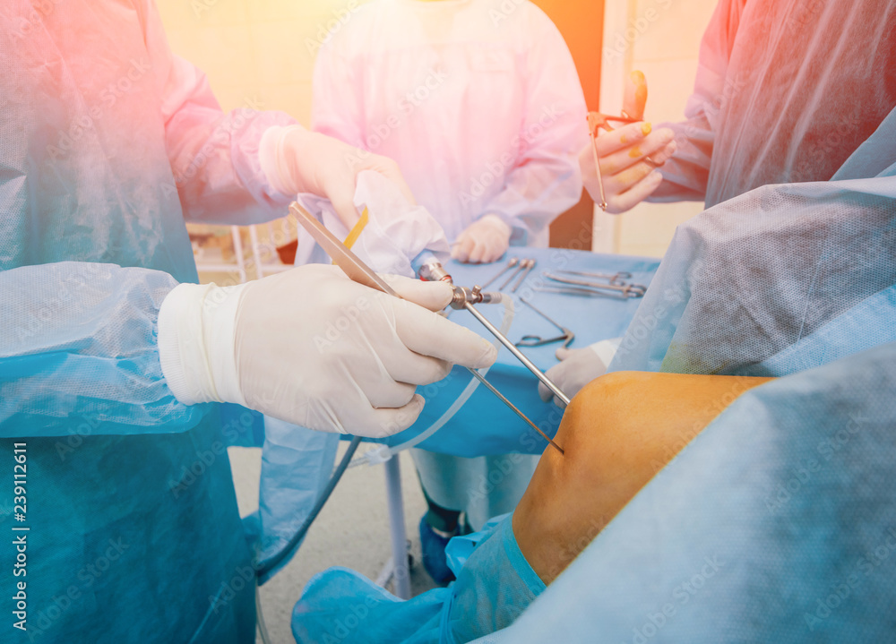 Arthroscope surgery. Orthopedic surgeons in teamwork in the operating ...