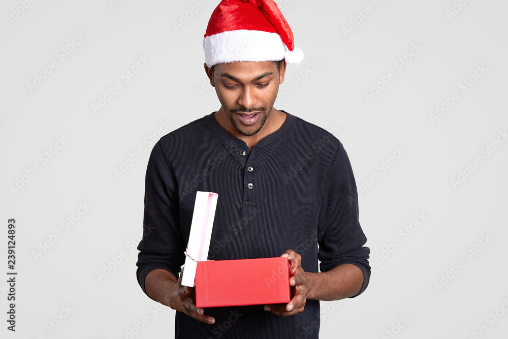 Suprised curious male Santa Claus wears festive hat, casual jumper ...