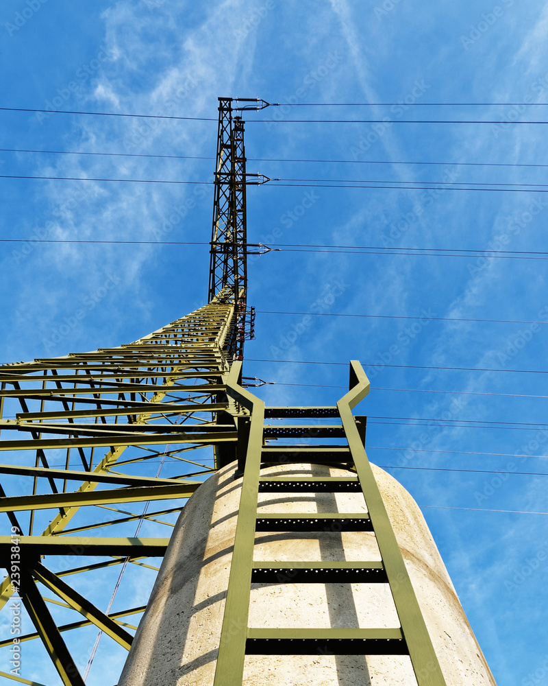 View from below up to a high voltage pylon, which stands on a concrete ...