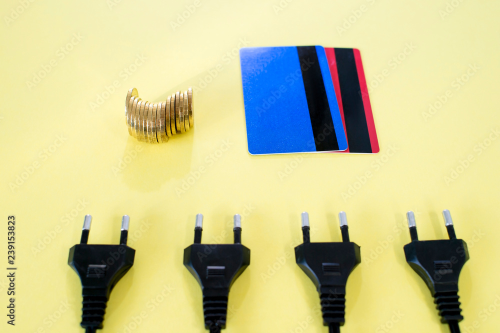 Plastic Bank cards with shiny coins and plugs connect on yellow ...