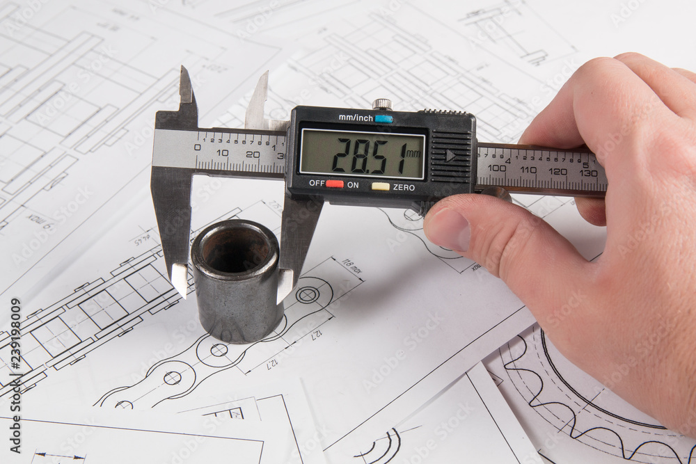 Engineer work. Measurement of the metal part with a caliper on the ...