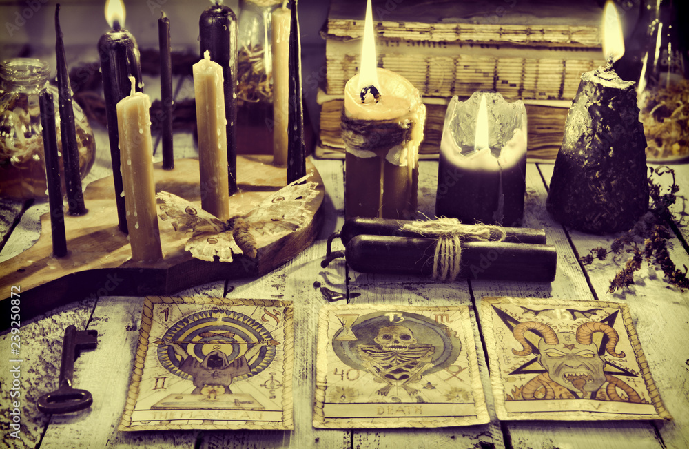 Vintage still life with black candles, key and old tarot cards. Magic ...