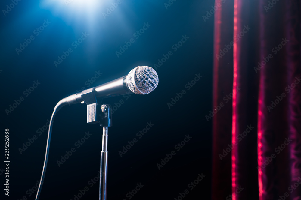 microphone on a stand up comedy stage with reflectors ray, high ...