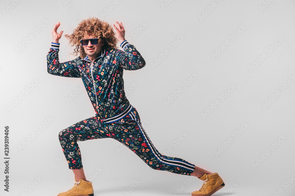 Adult positive smiling funky man with curly hair style in suglasses and ...