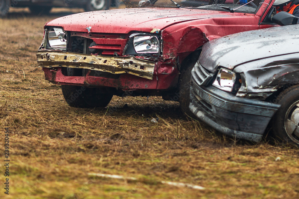 a race of cars that hit each other. old broken cars in crashes during a ...