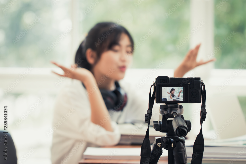 Happy young Asian singer woman beauty blogger or vlogger recording ...