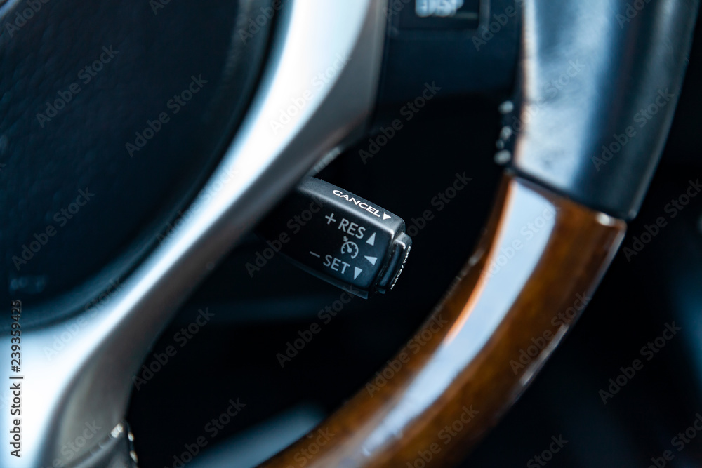 The shift lever to set the automatic cruise control speed inside the ...