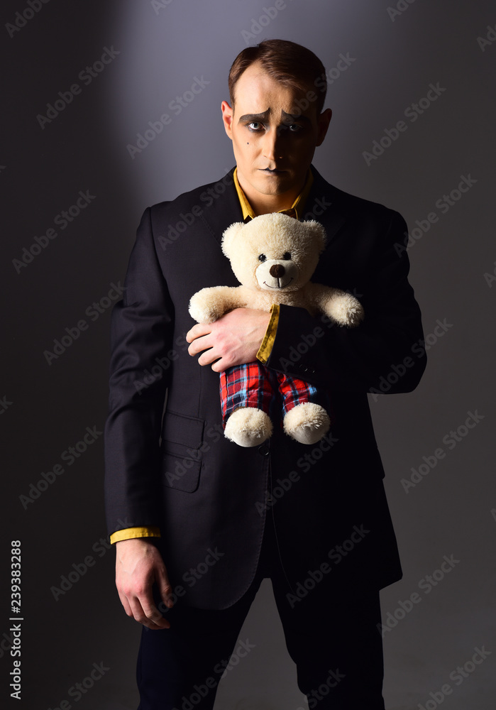 Depressed and lonely. Mime man hold teddy bear toy. Stage actor with ...