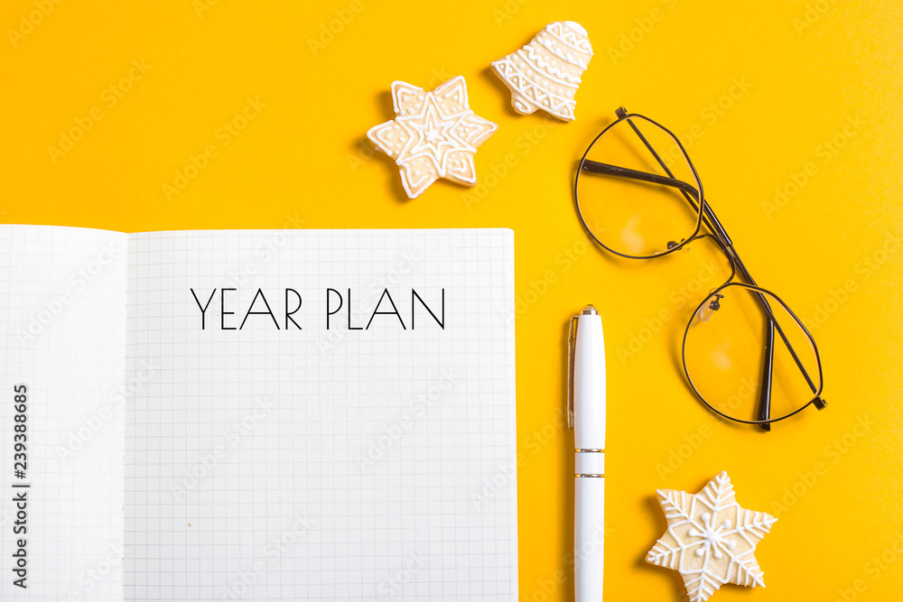 Year plan written in a notebook with clean sheets, which lies next to ...