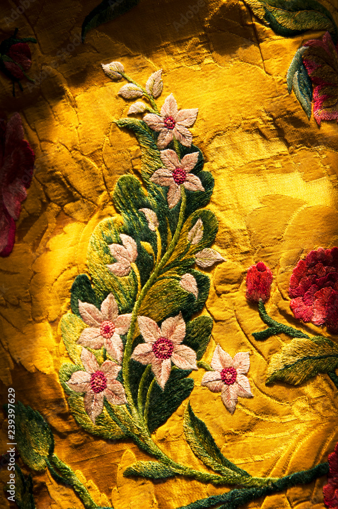 I have owned this a piece of gold coloured silk fabric embroidered with ...