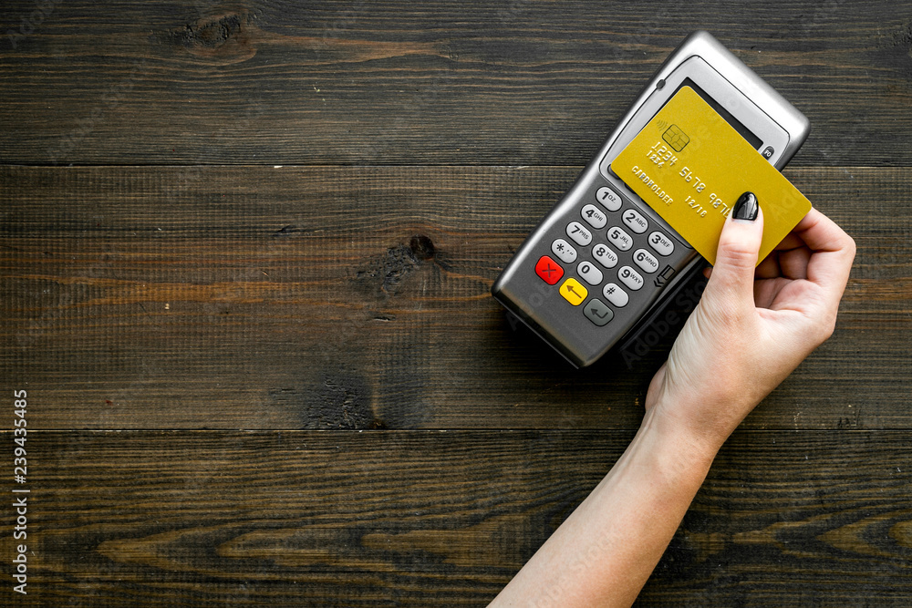 Pay by payment terminal. Paypass technology. Woman's hand hold credit ...